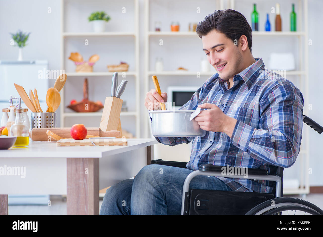Disabled man preparing soup at kitchen Stock Photo - Alamy