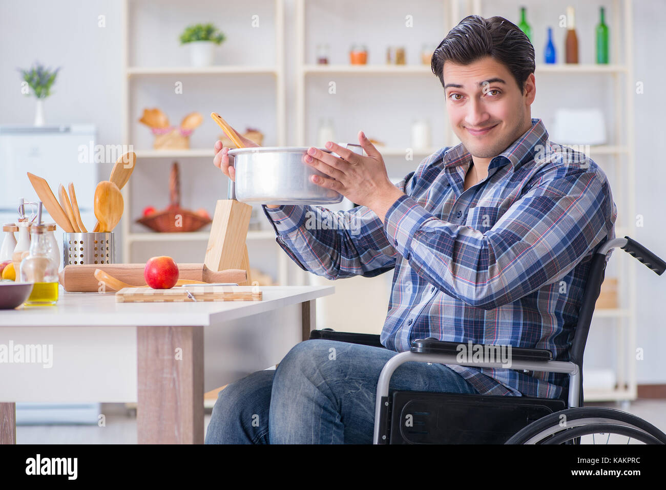 Disabled man preparing soup at kitchen Stock Photo - Alamy