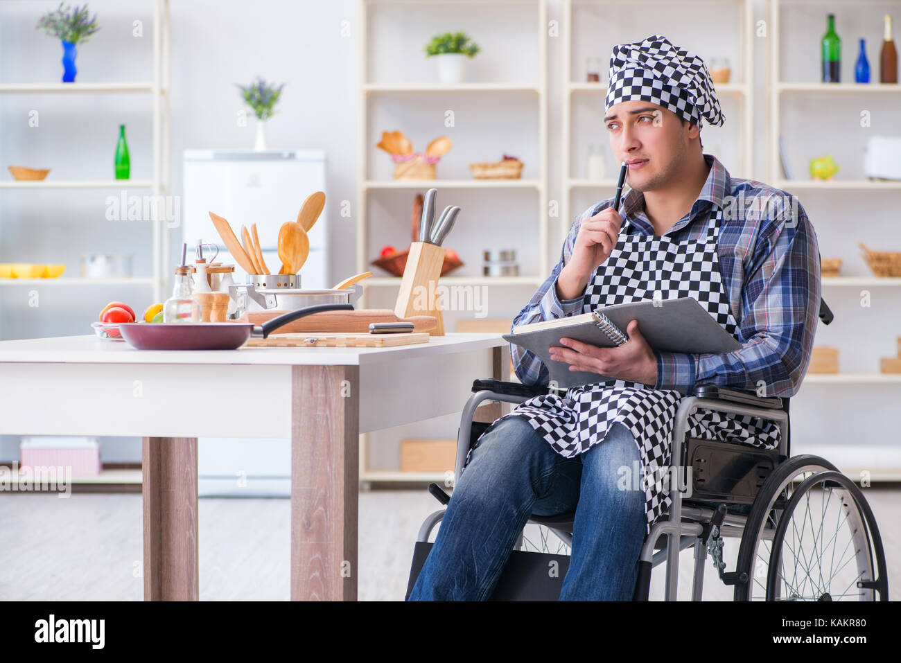 Young man cook with book of food recipes Stock Photo - Alamy