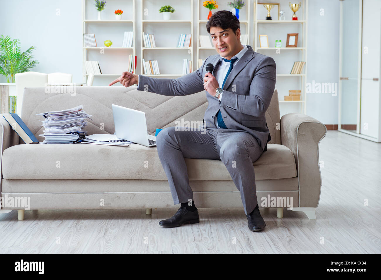 Sad businessman singing in office Stock Photo - Alamy