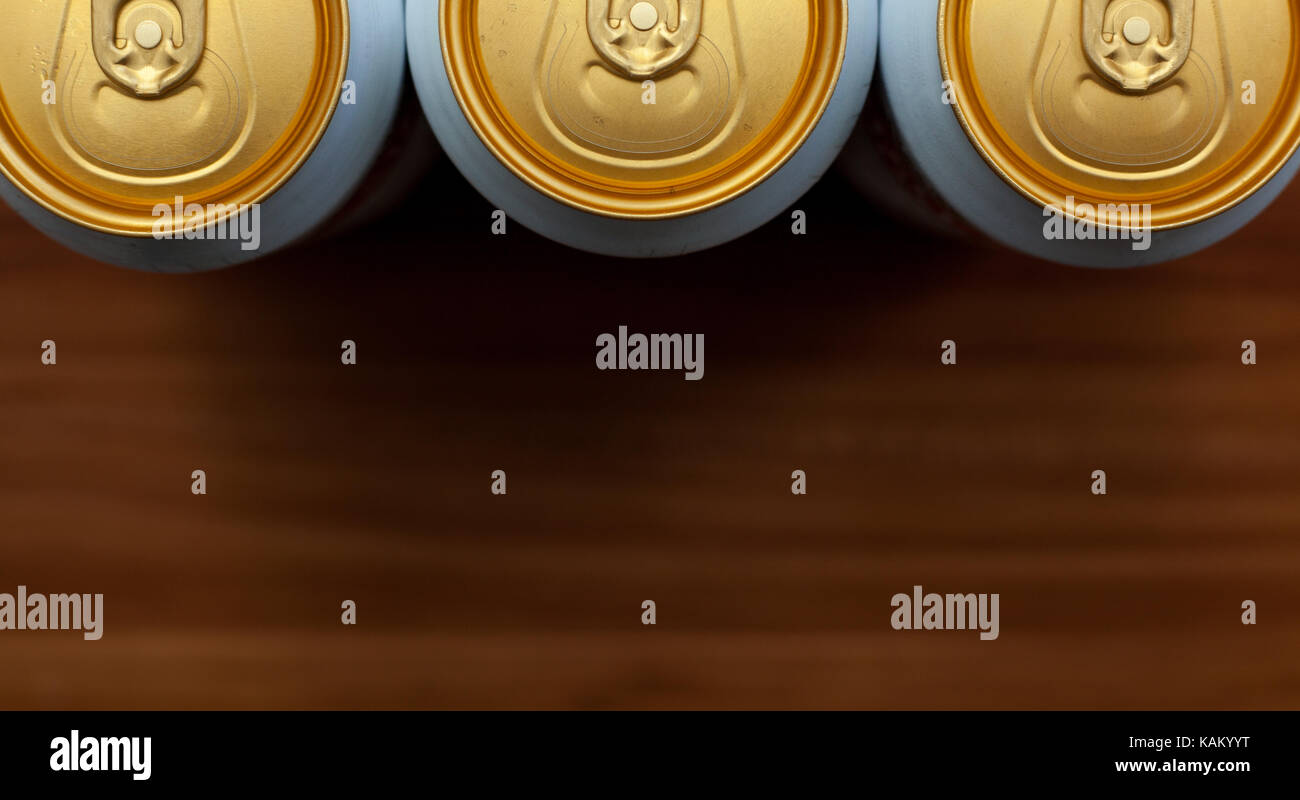 closeup photo of three beer cans on a wooden table Stock Photo - Alamy