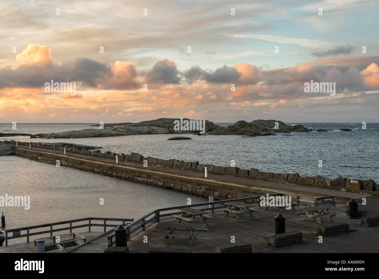 Early morning. Benches in front of the sea, with Faerder National Park ...