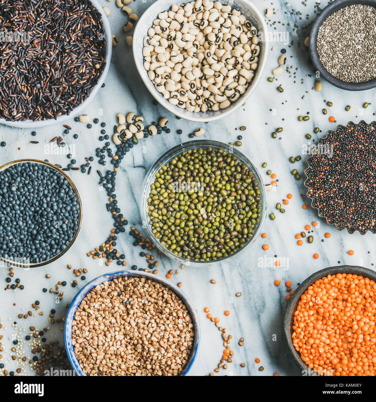 Various raw uncooked grains, beans, cereals, marble background, square ...