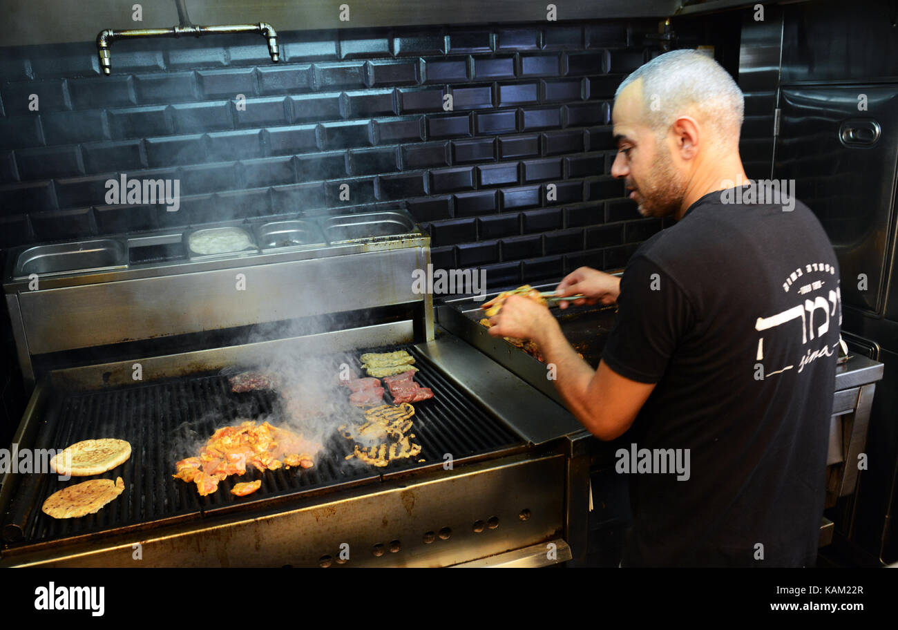Grilling the meat at the popular Sima restaurant in Jerusalem's Mahane ...