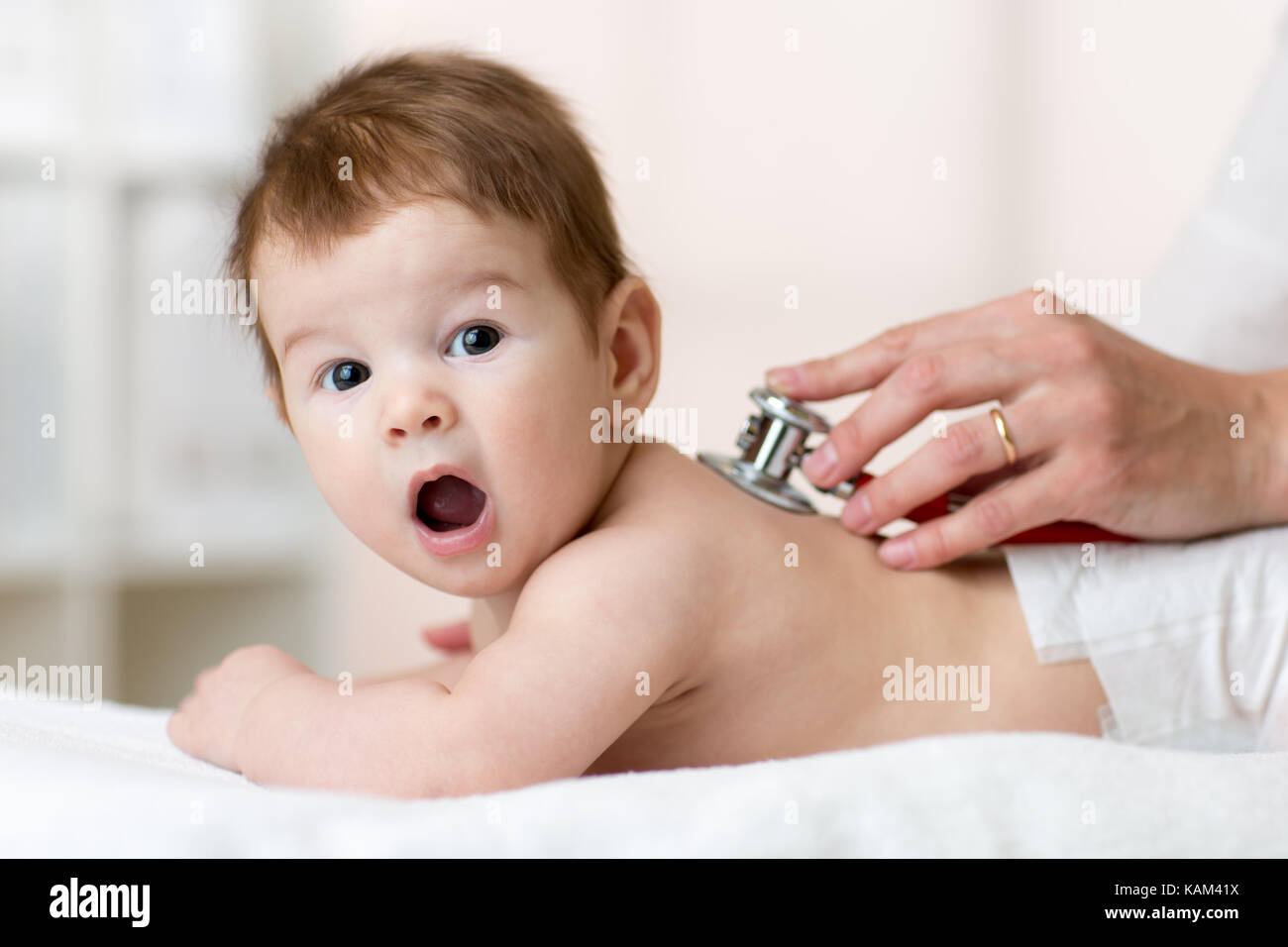 Pediatrician examining baby with stethoscope Stock Photo - Alamy