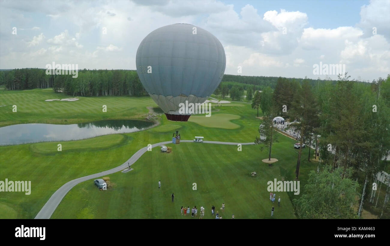 Big air balloon in white color with basket. Aerial on the big balloon ...