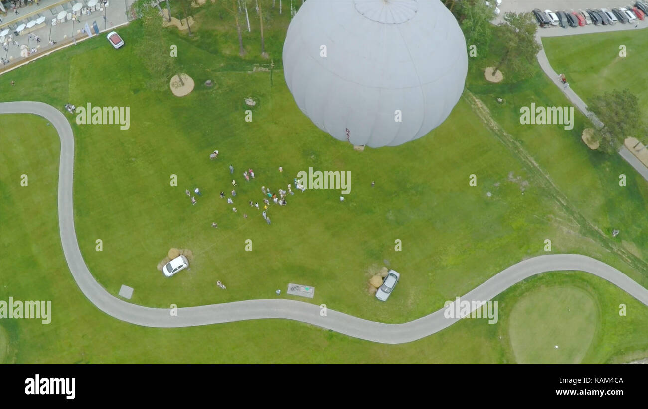 Big air balloon in white color with basket. Aerial on the big balloon ...
