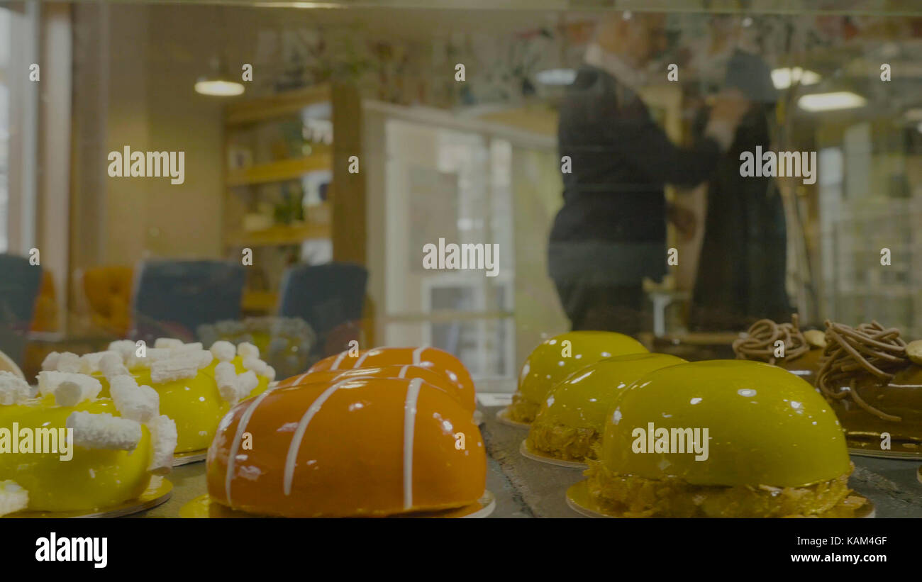 Different types of cakes in pastry shop glass display. View from the ...