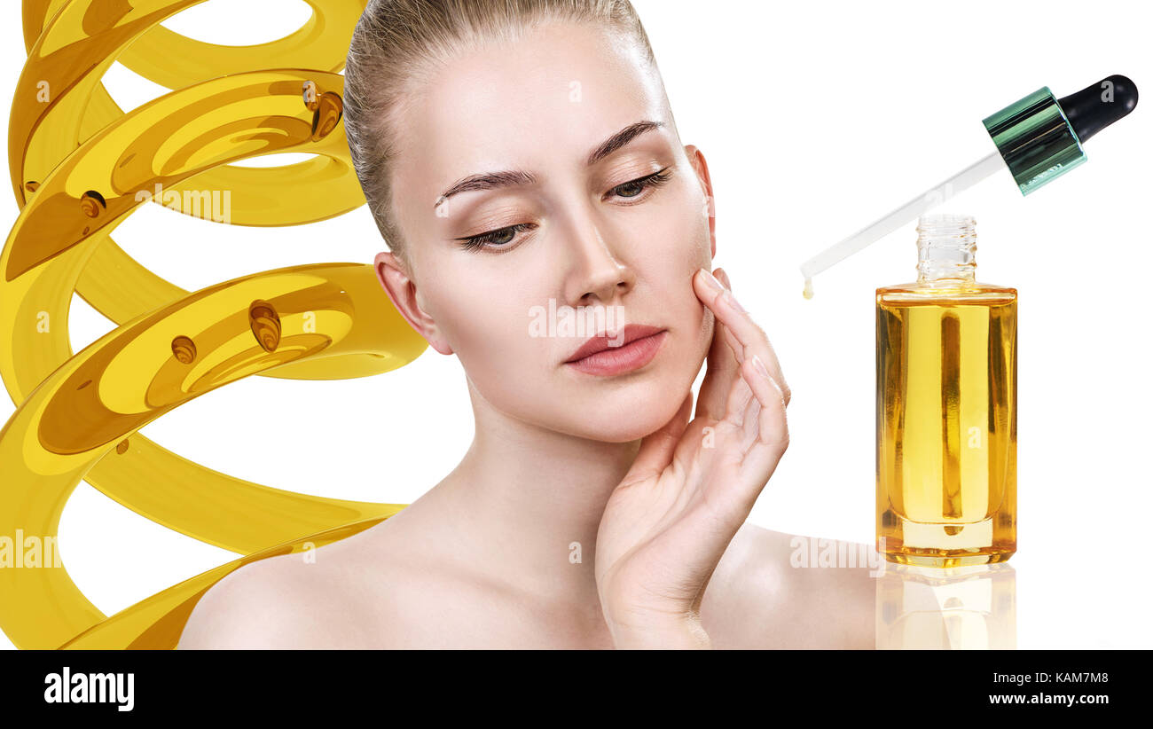 Cosmetic oil applying on face of young woman Stock Photo - Alamy