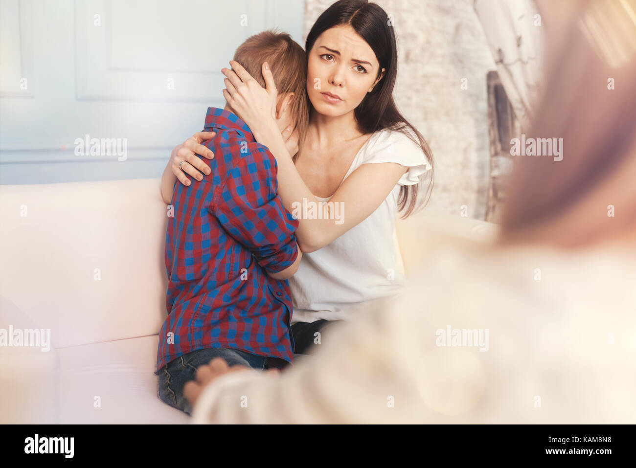 Troubled mother and her son talking with a psychologist Stock Photo - Alamy