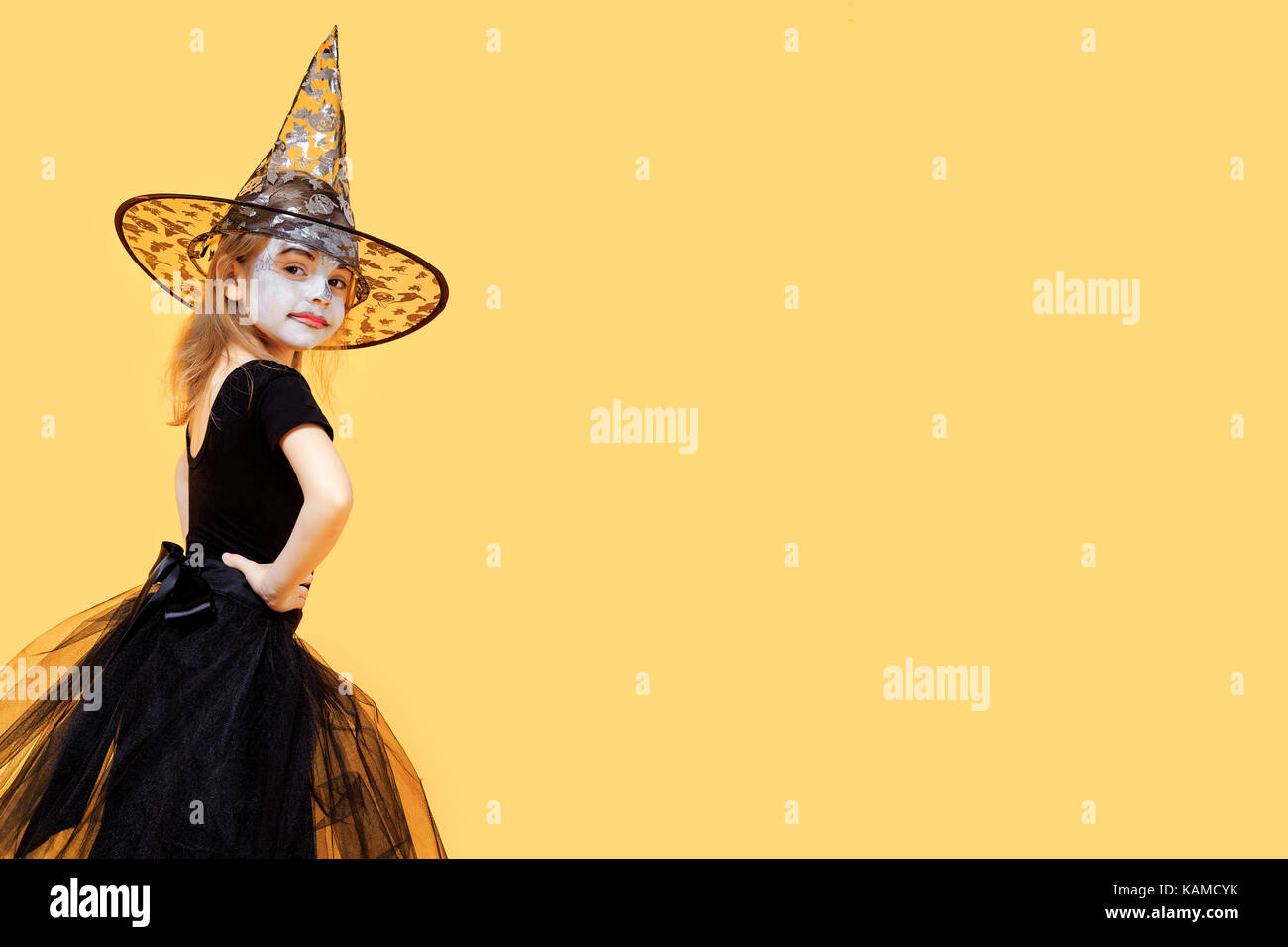 Proud small girl in witch costume Stock Photo - Alamy