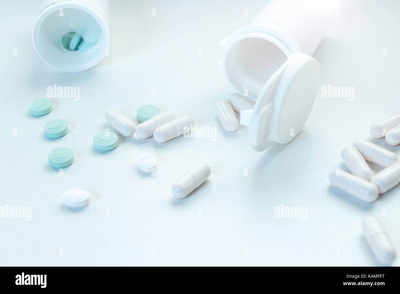 White capsules and blue tablets RX medication isolated on white ...