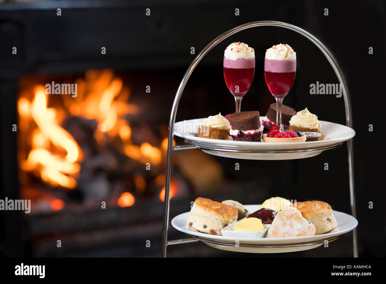 Afternoon tea platter served in front of a roaring orange warm log fire ...