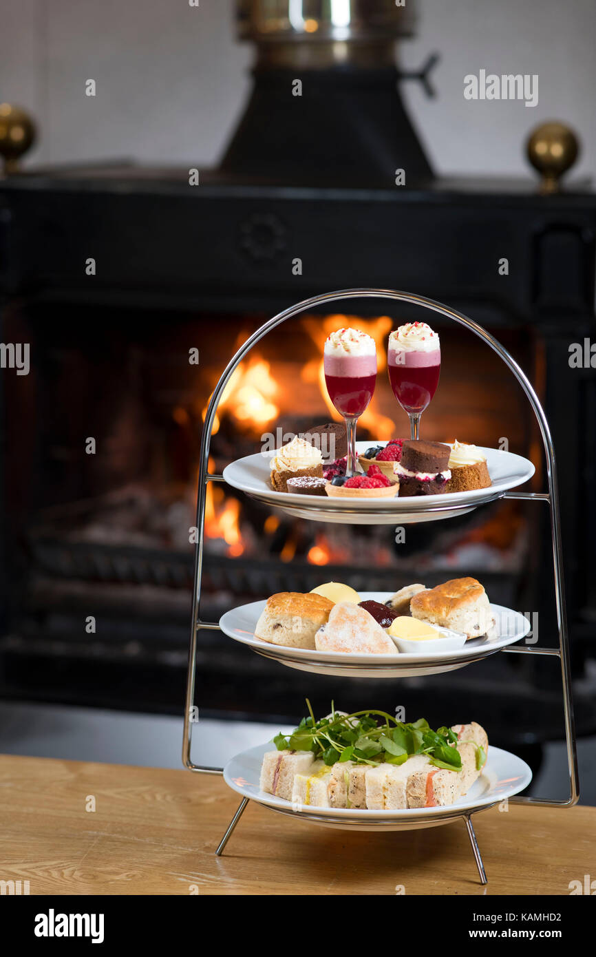 Afternoon tea platter served in front of a roaring orange warm log fire ...