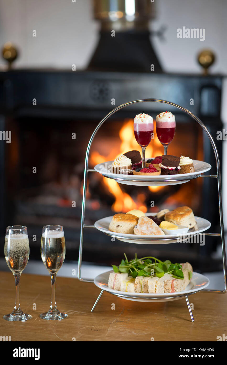 Afternoon tea platter served in front of a roaring orange warm log fire ...