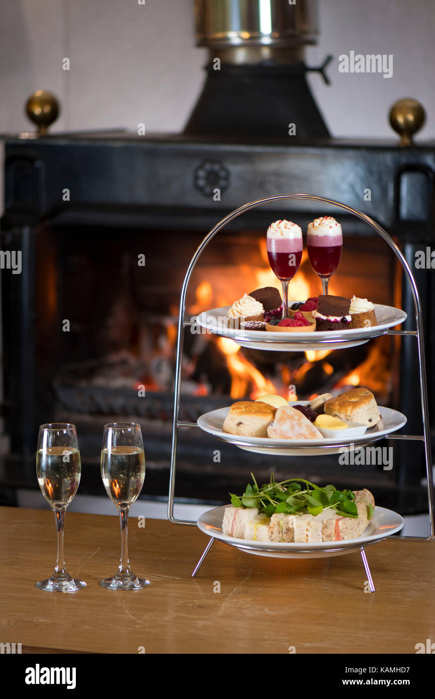 Afternoon tea platter served in front of a roaring orange warm log fire ...