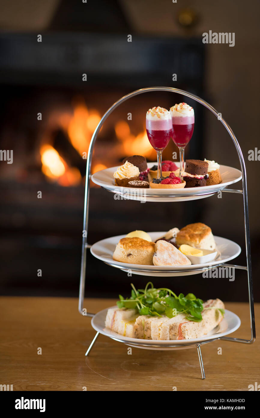 Afternoon tea platter served in front of a roaring orange warm log fire ...