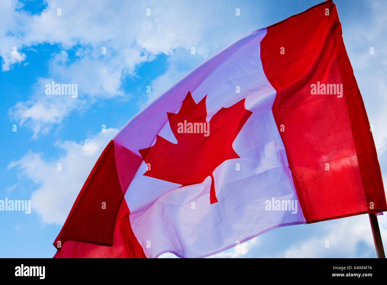 National flag of Canada on clear blue sk Stock Photo - Alamy