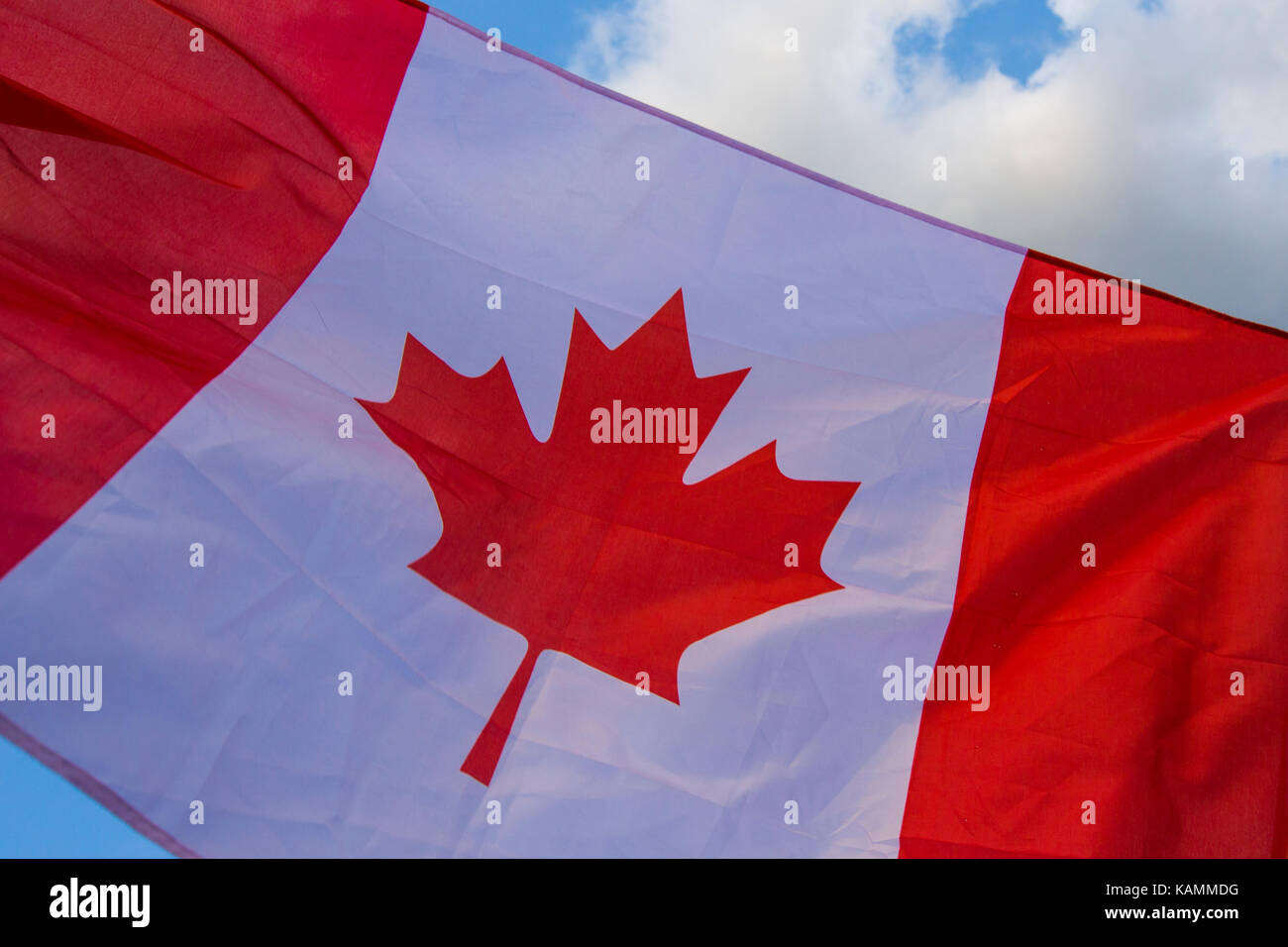 National flag of Canada on clear blue sk Stock Photo - Alamy