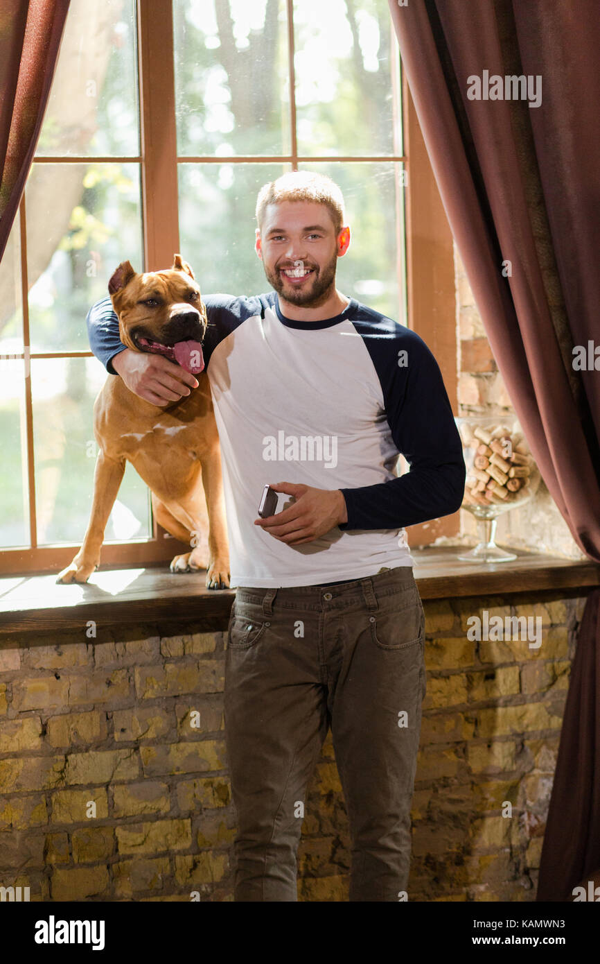 View of happy young man and his dog Stock Photo - Alamy
