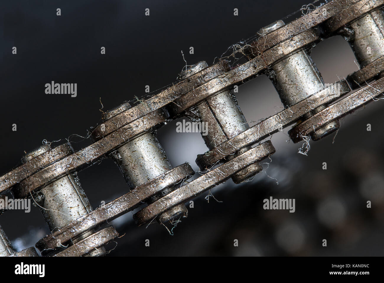 A close-up view of a chain circling the cogwheel. Part of a machine ...
