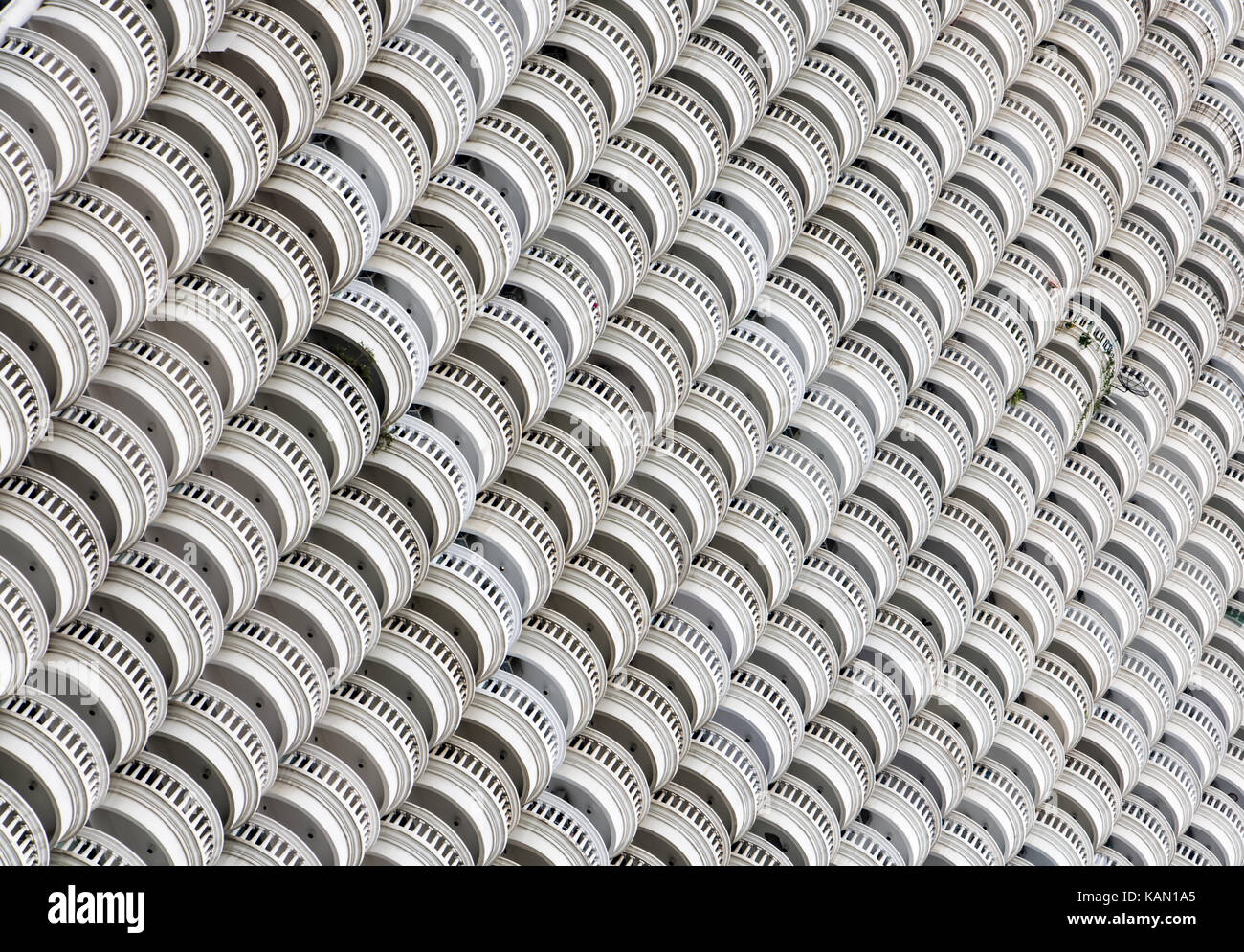 Facade of a high-rise house with many half-round balconies. Diagonal ...
