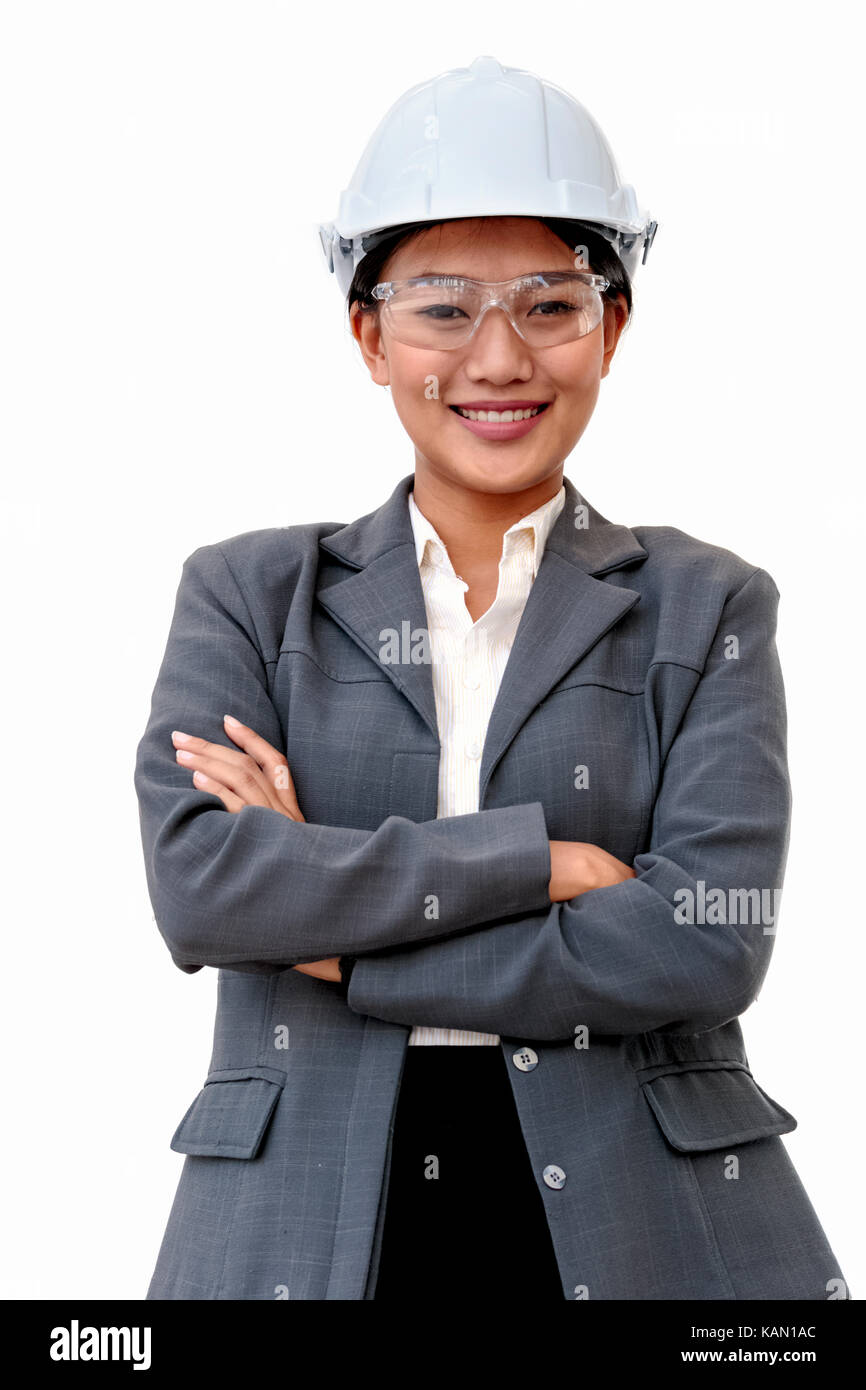 female engineer wearing white helmet standing with arm cross on white ...