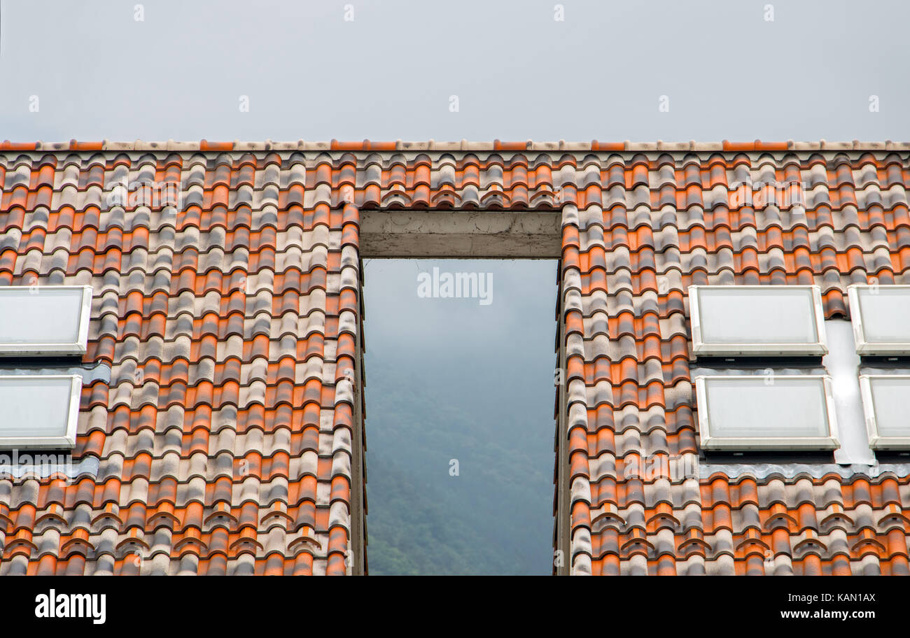 The gap between the houses is covered with a small roof. Two houses are ...