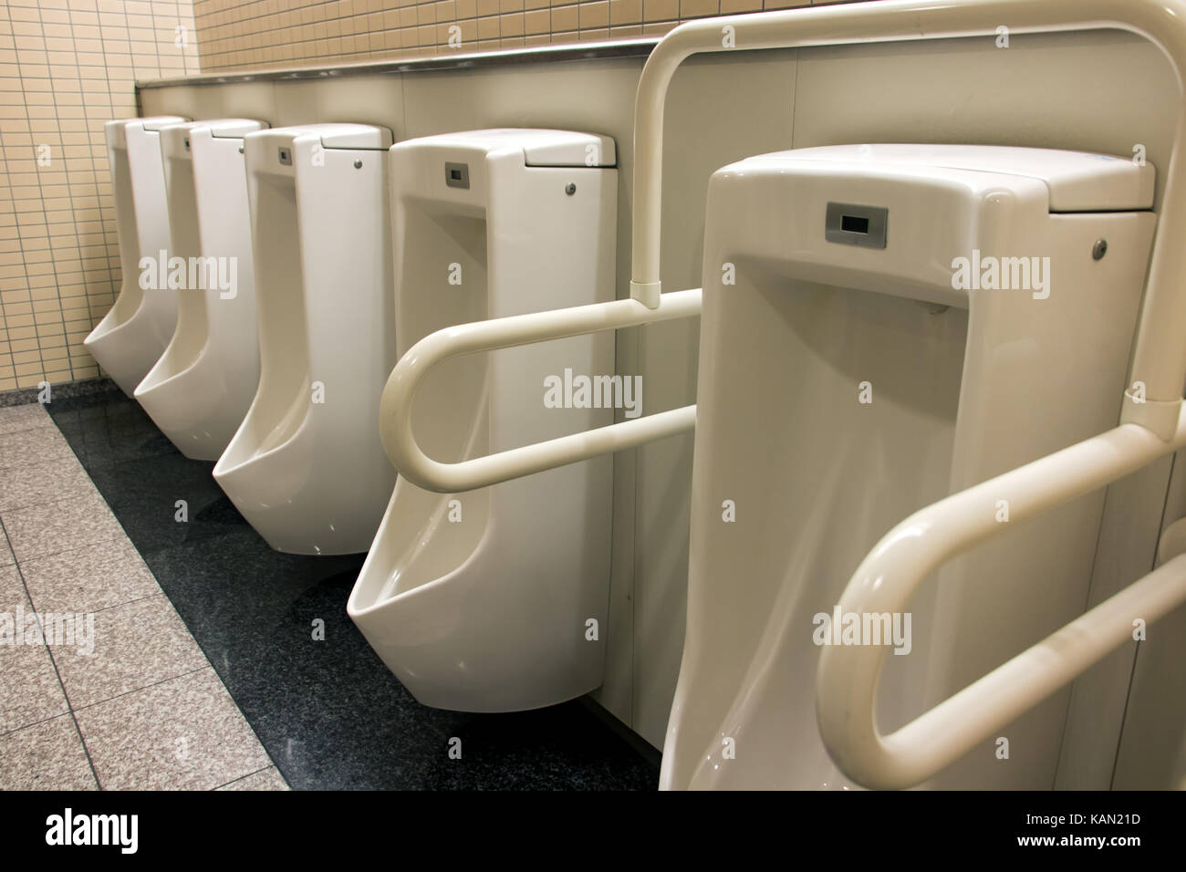 A line of urinals at a public toilet. Pure men's toilets in a ...