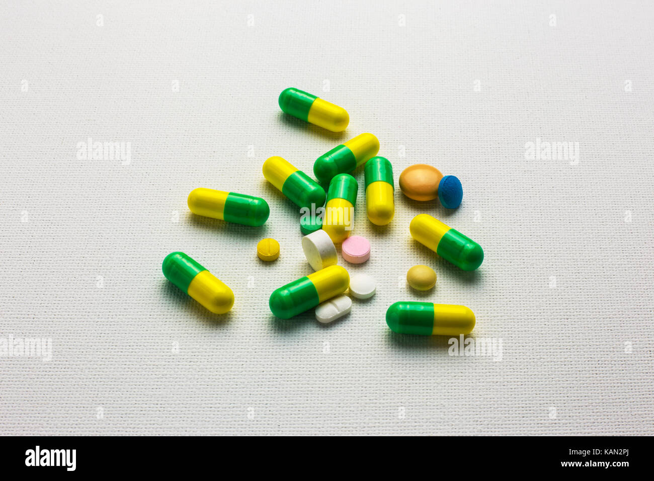 Many tablets and capsules pills on white canvas background Stock Photo ...