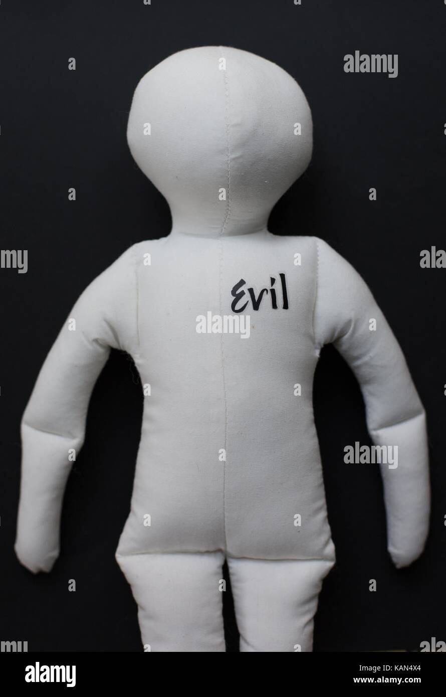 A blank white doll with a name tag "Evil Stock Photo - Alamy
