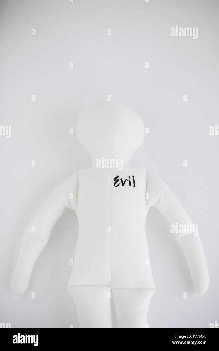 A blank white doll with a name tag "Evil Stock Photo - Alamy