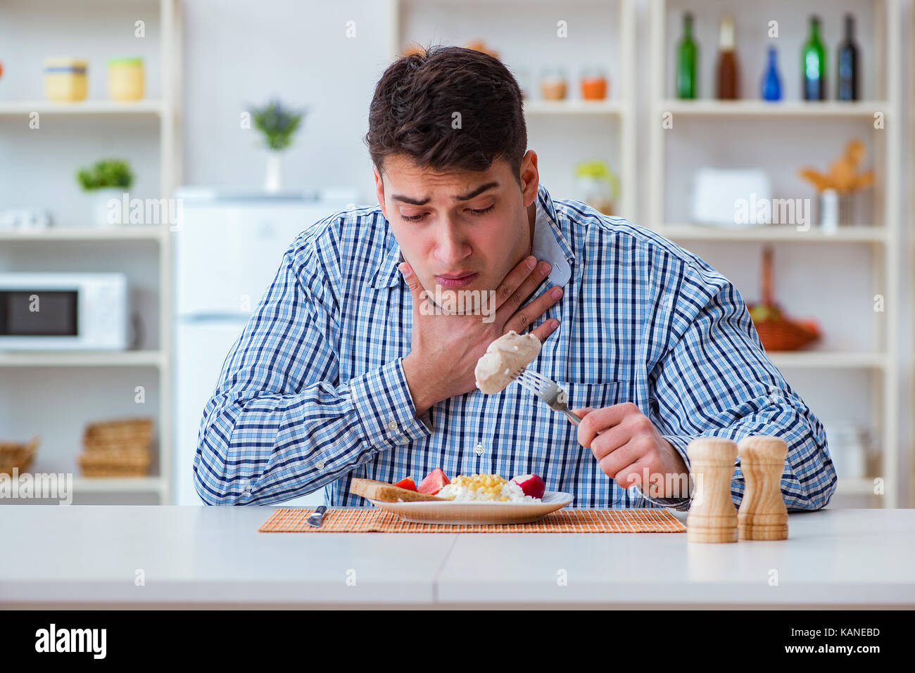 Man eating tasteless food at home for lunch Stock Photo - Alamy