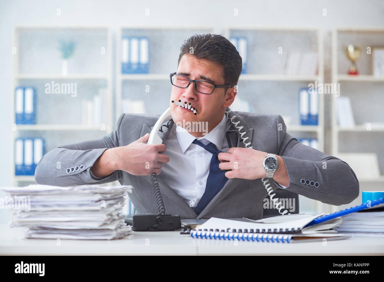 Businessman smoking in office at work Stock Photo - Alamy