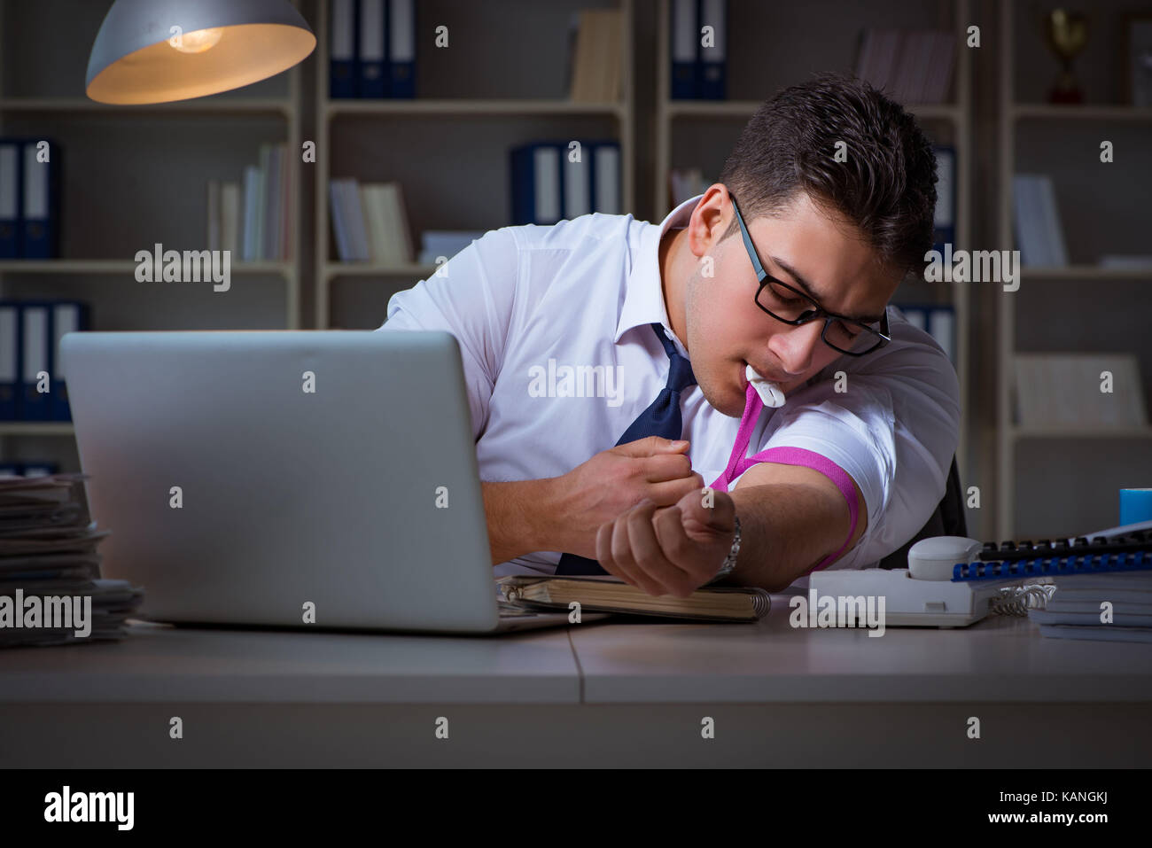 Businessman staying late in office for drugs Stock Photo - Alamy