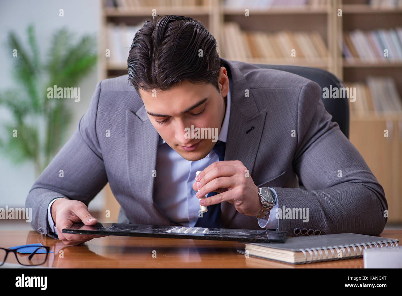 Drug addict businessman in the office Stock Photo - Alamy