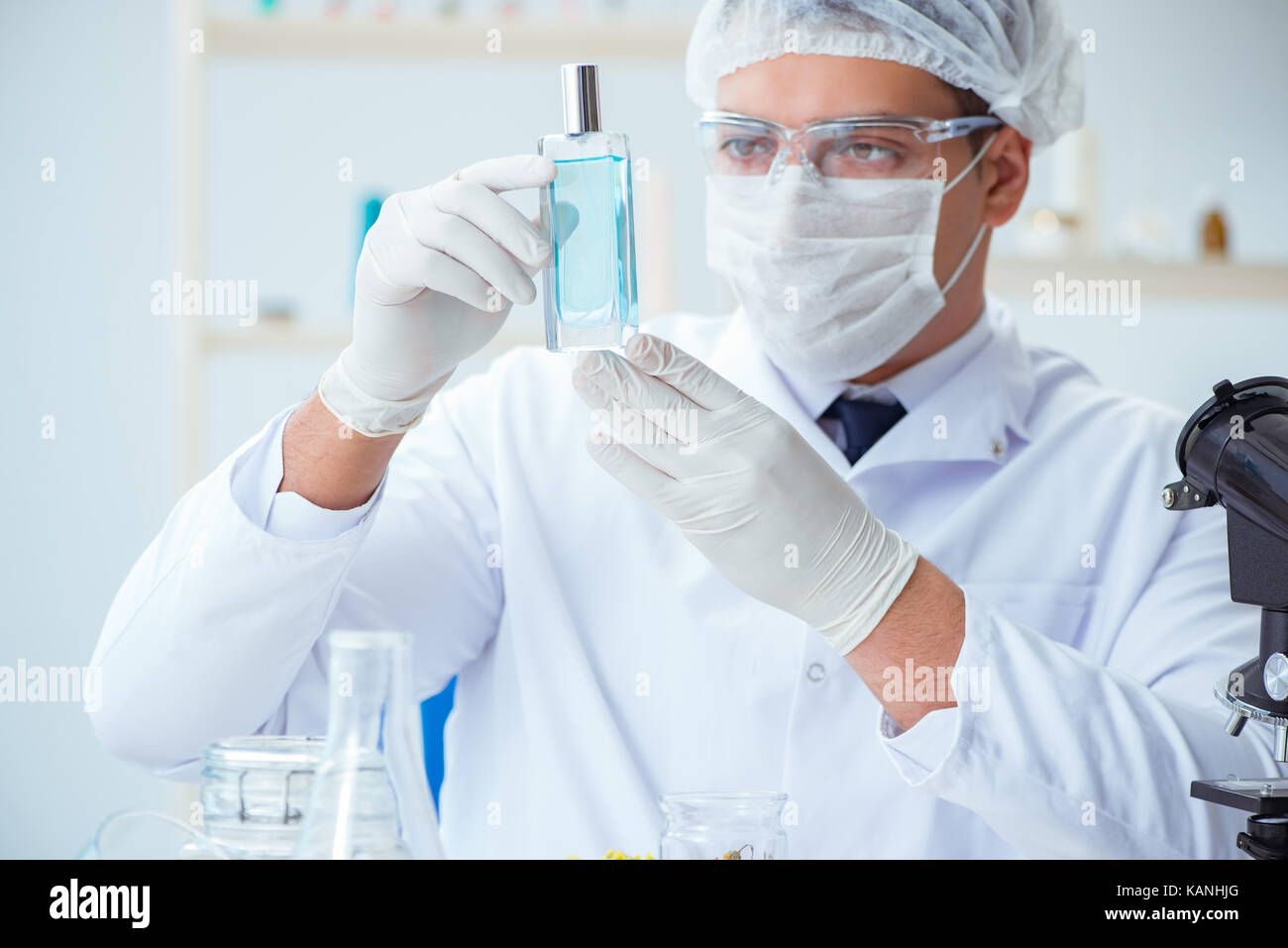 Chemist mixing perfumes in the lab Stock Photo - Alamy