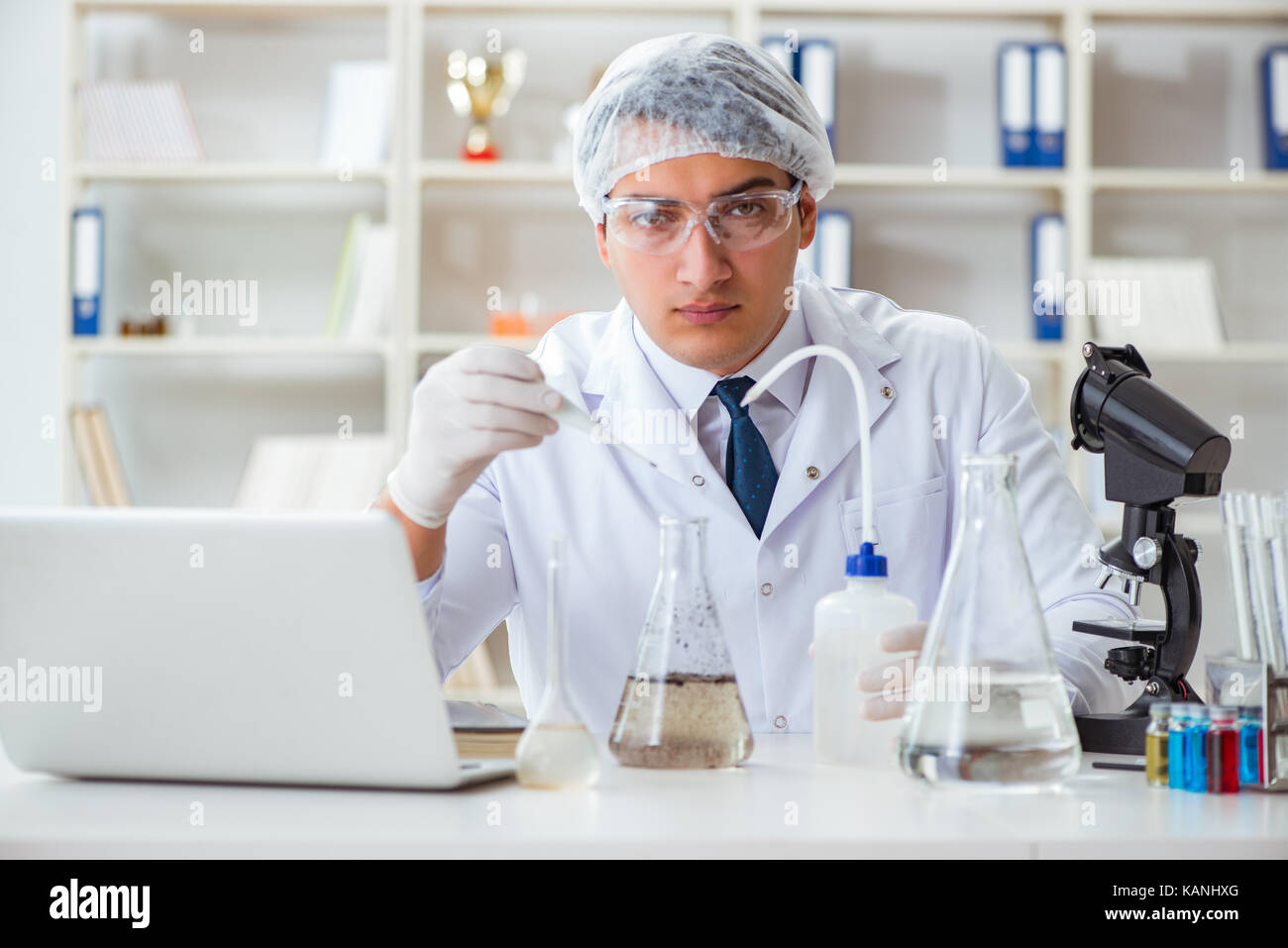 Young researcher scientist doing a water test contamination experiment ...