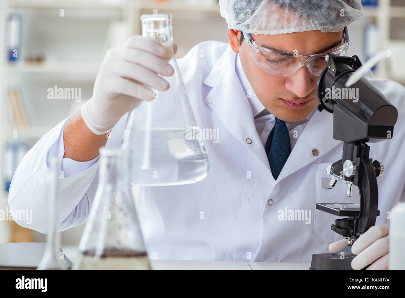Young researcher scientist doing a water test contamination experiment ...