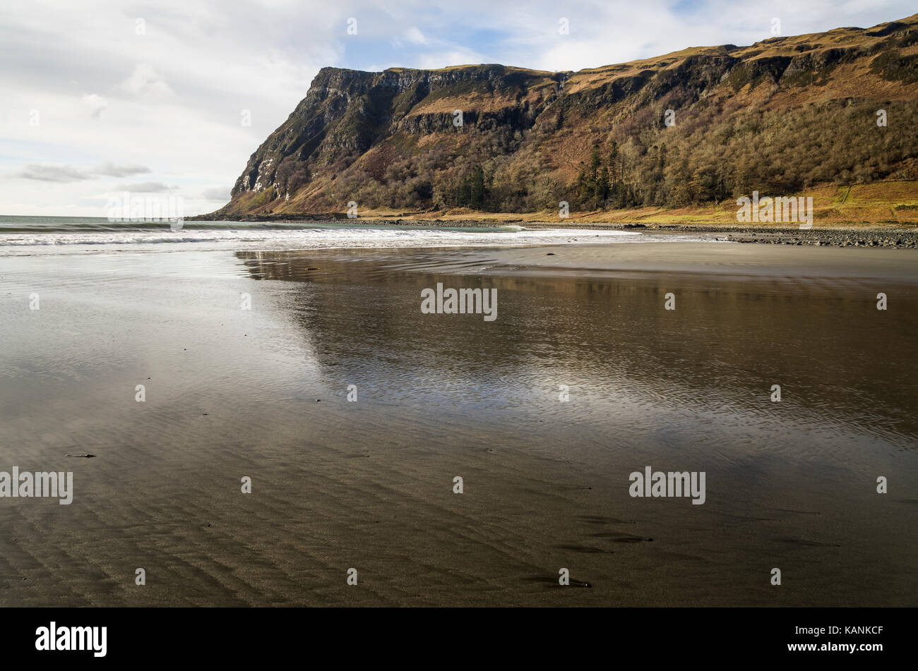 Landscape of Cliffs on Carsaig Bay reflected in the sand on the beach ...