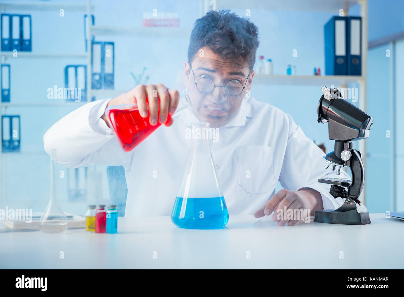 Funny mad chemist working in a laboratory Stock Photo - Alamy