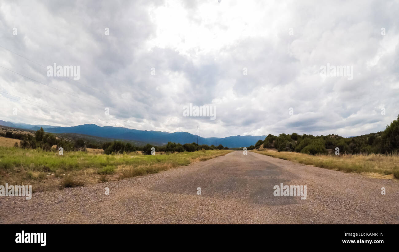 Driving in rural area of Western Colorado on cloudy day Stock Photo - Alamy
