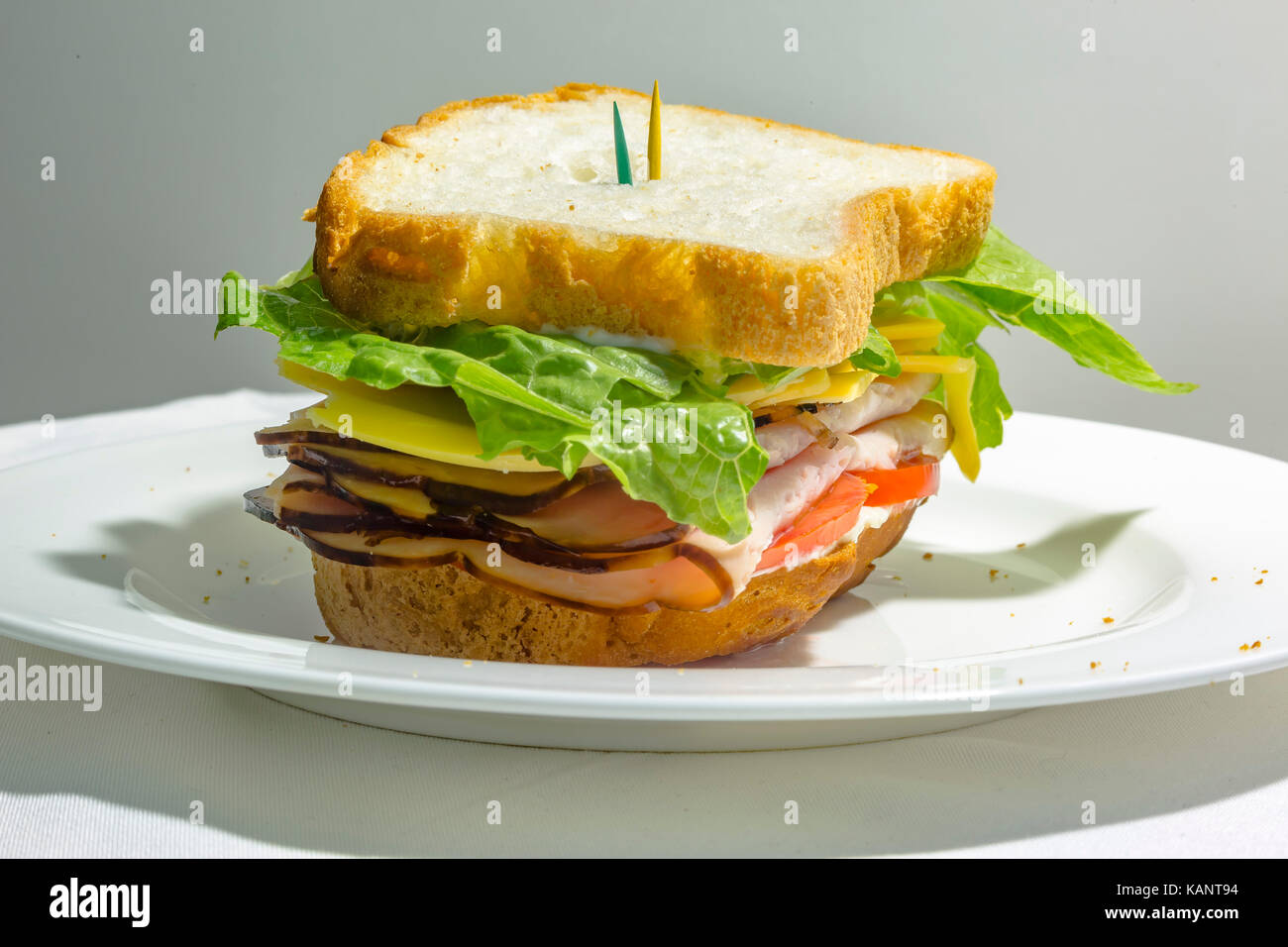 Close up of a sandwich on the side at eye level with toothpicks and ...