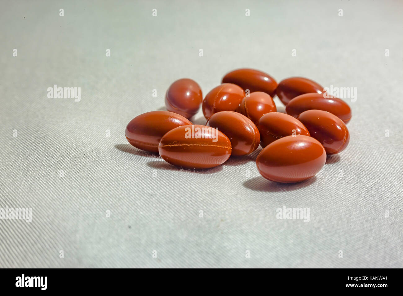Group of pills on a white background with fabric texture shot in studio ...