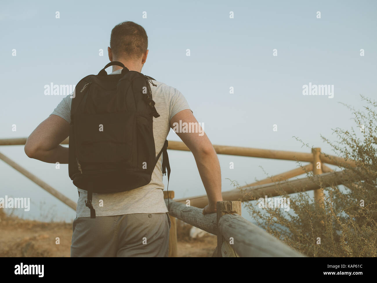 Man with backpack rises up the hill Stock Photo - Alamy