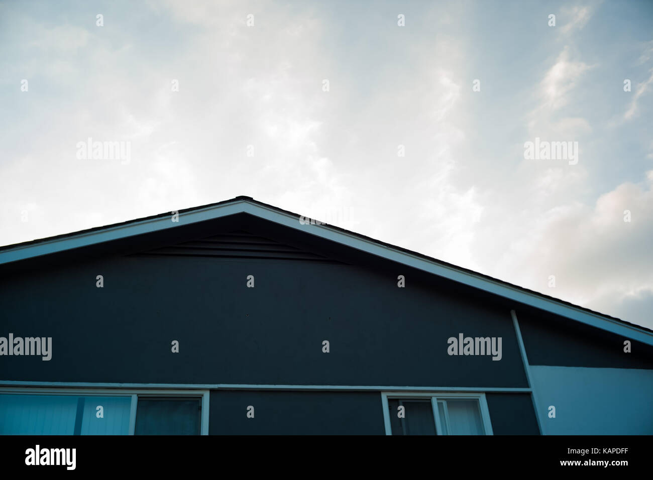 Generic Roof against a blue sky with clouds Stock Photo - Alamy