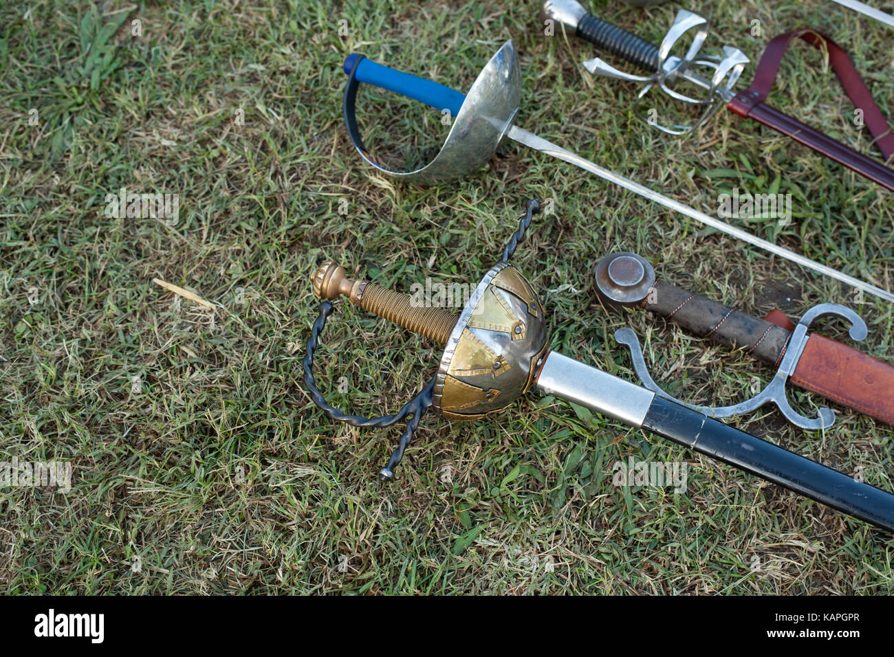 Swords and sabers on grass during the historical Reenactment in ...
