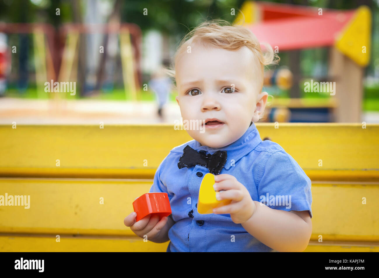 nice boy sitting on bench Stock Photo - Alamy