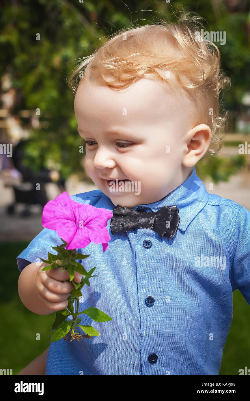little boy holding flower Stock Photo - Alamy