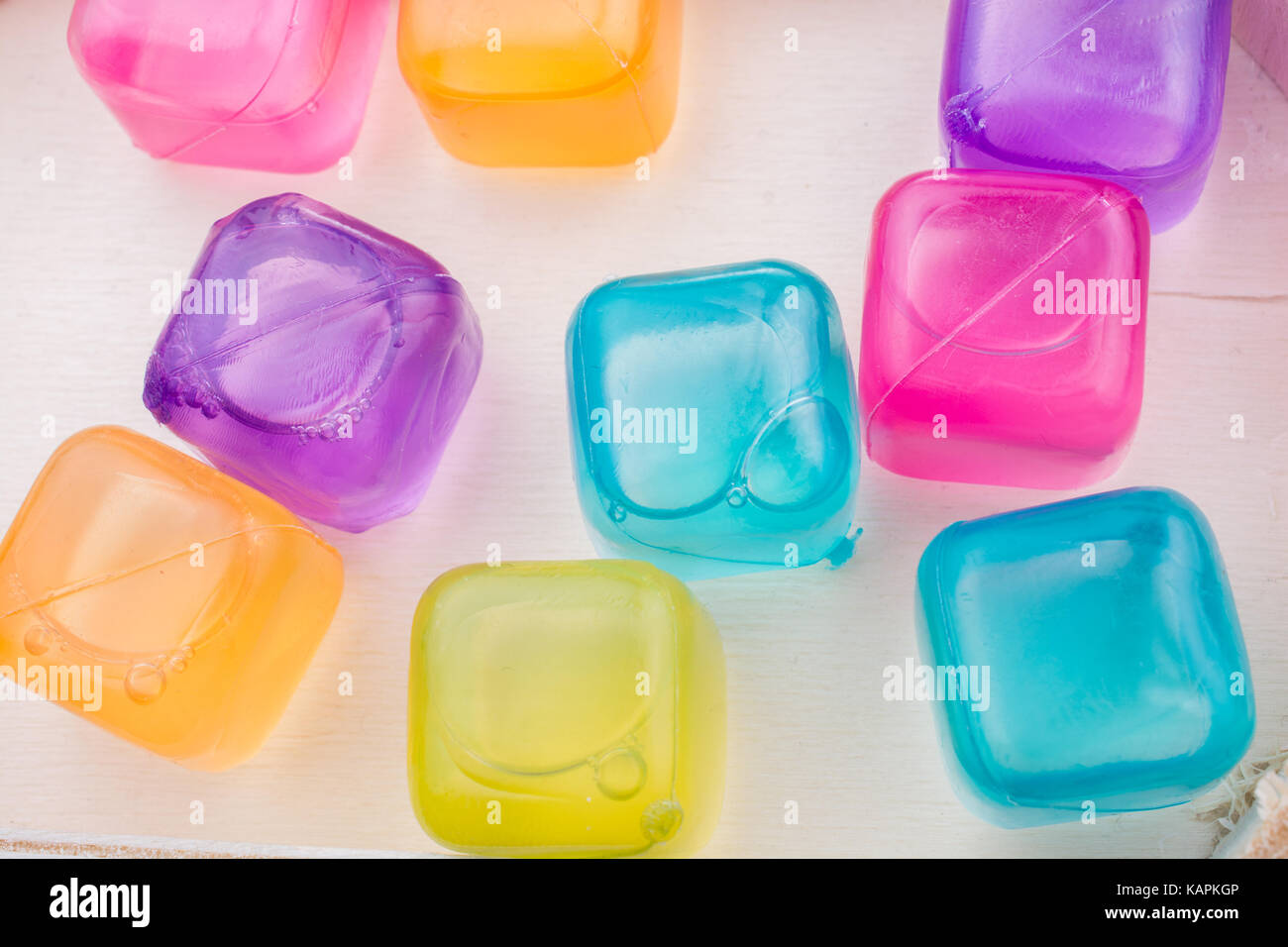 Fake colorful ice cubes on a brown background Stock Photo - Alamy
